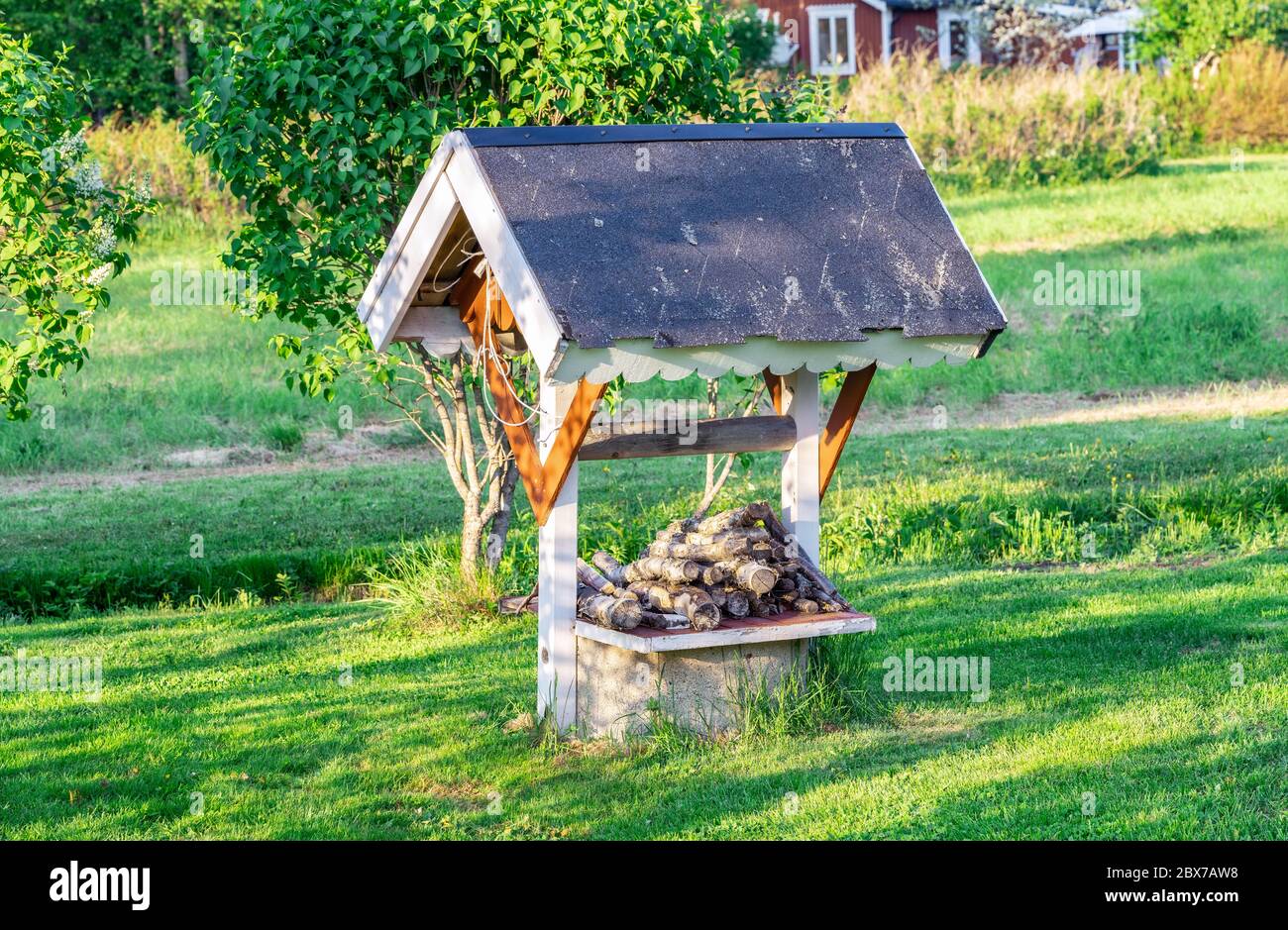 Decorative wooden well in the garden. Typical Red colored wooden ...
