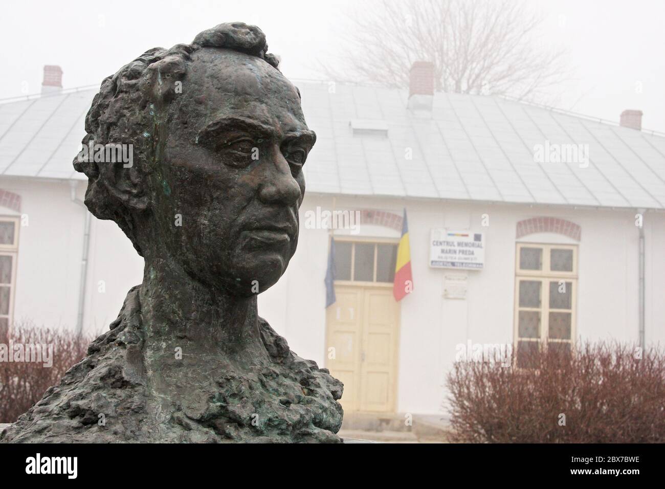 A bust of the Romanian writer Marin Preda in front of the memorial ...