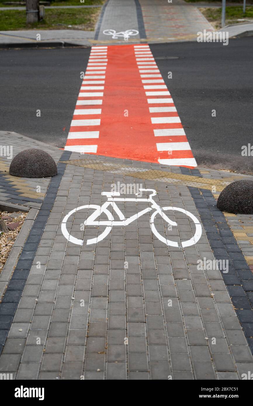 Cycling path with a symbol of bike on a ground through avtomobile road ...