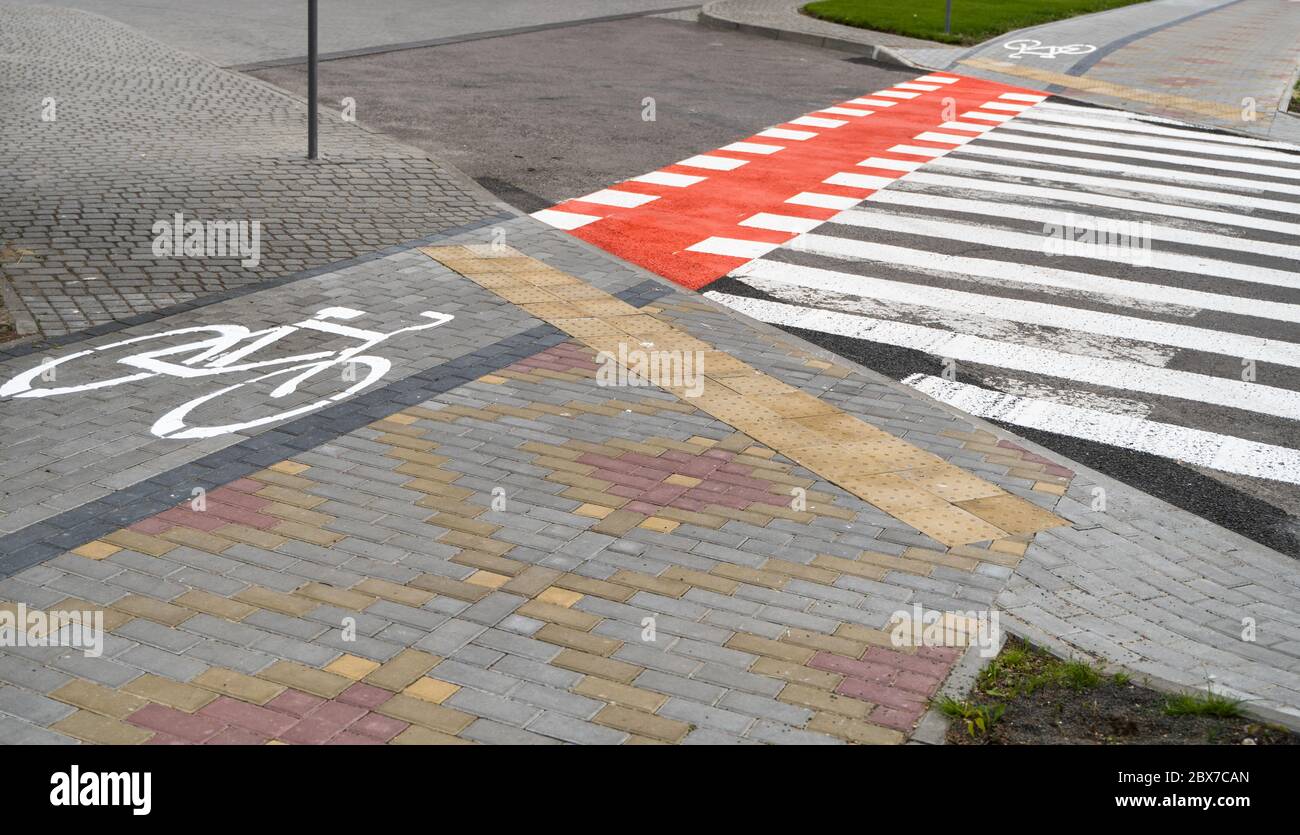 Cycling path with a symbol of bike on a ground through avtomobile road ...