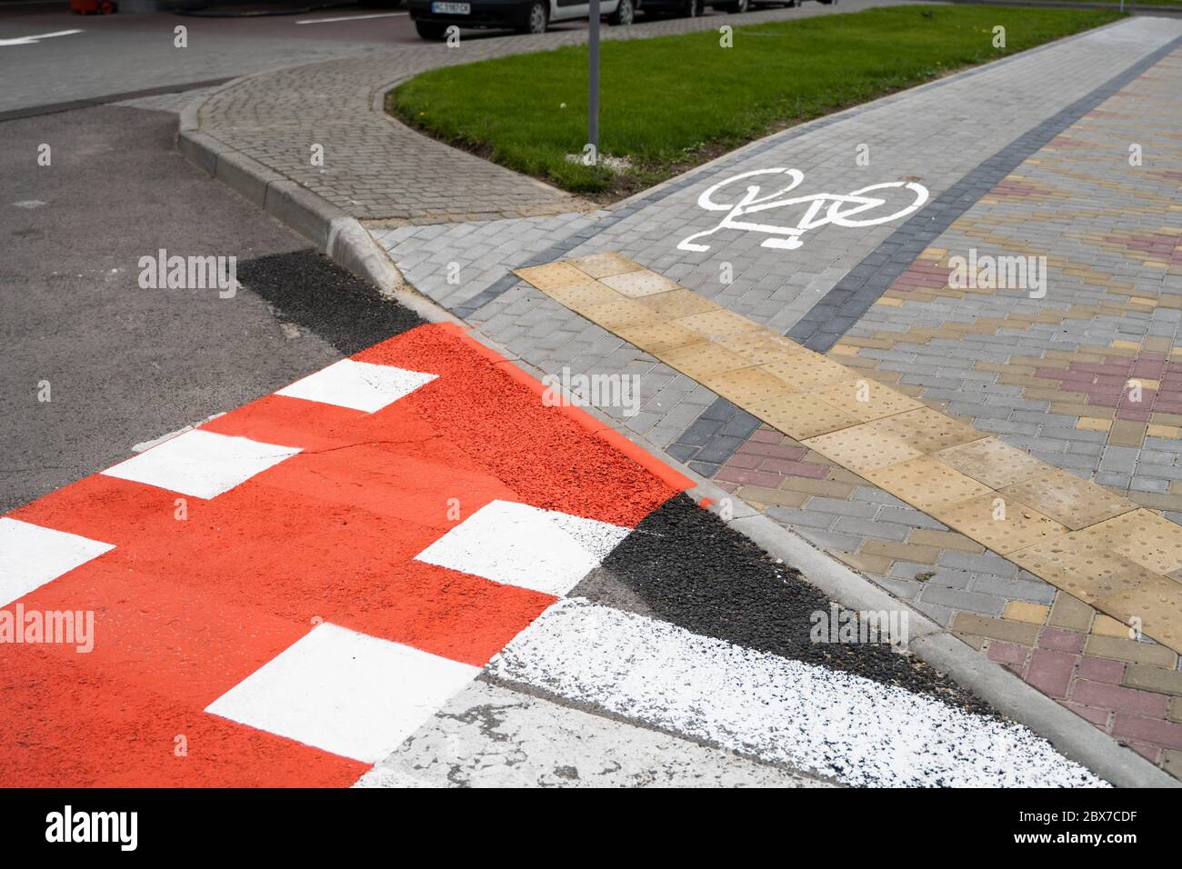Cycling path with a symbol of bike on a ground through avtomobile road ...