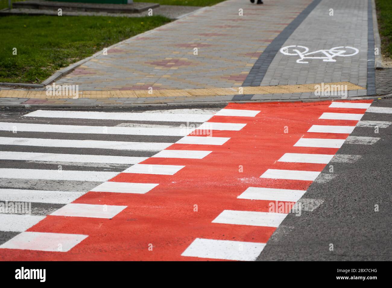 Cycling path with a symbol of bike on a ground through avtomobile road ...