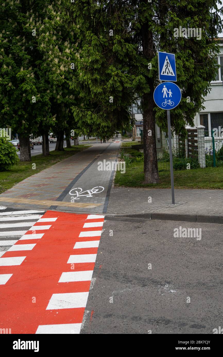 Cycling path with a symbol of bike on a ground through avtomobile road ...