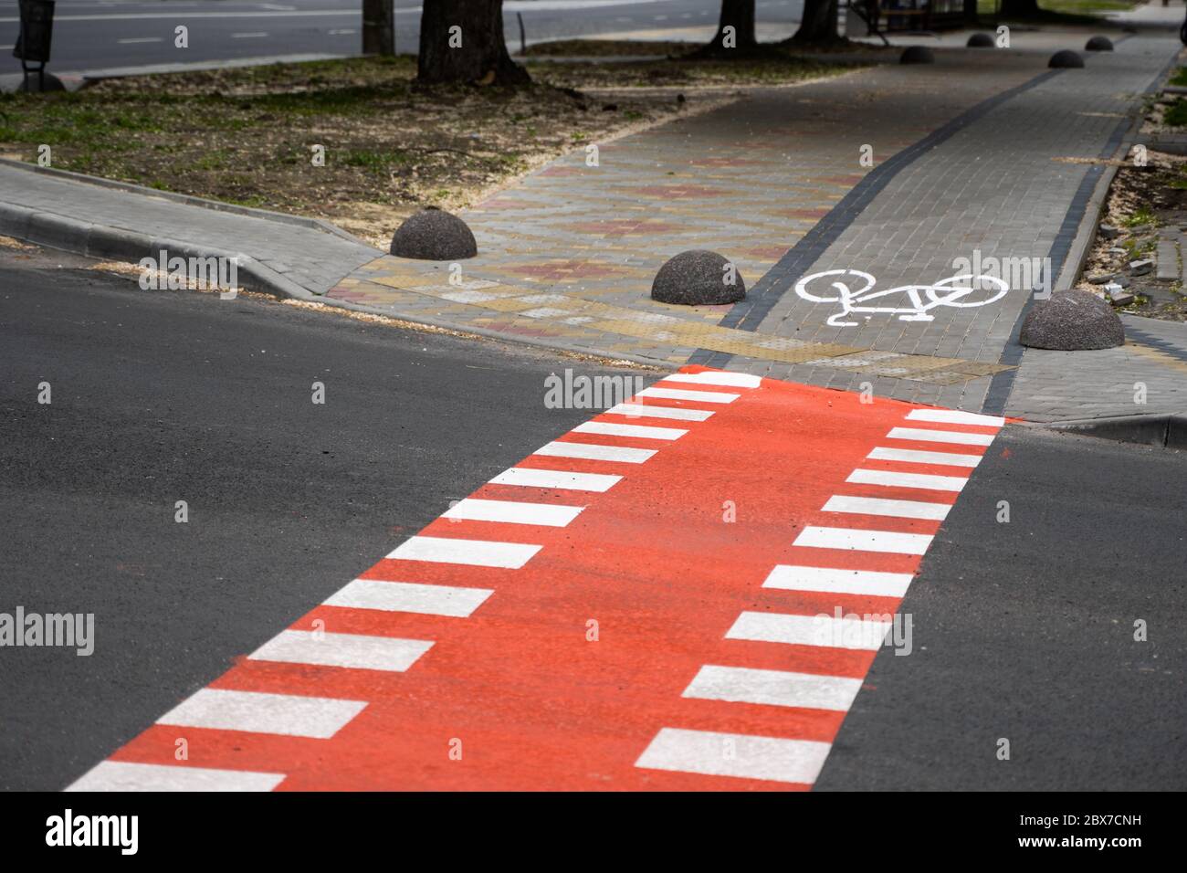 Cycling path with a symbol of bike on a ground through avtomobile road ...