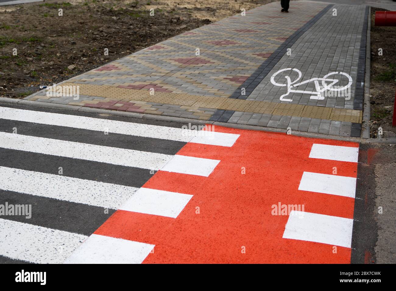 Cycling path with a symbol of bike on a ground through avtomobile road ...
