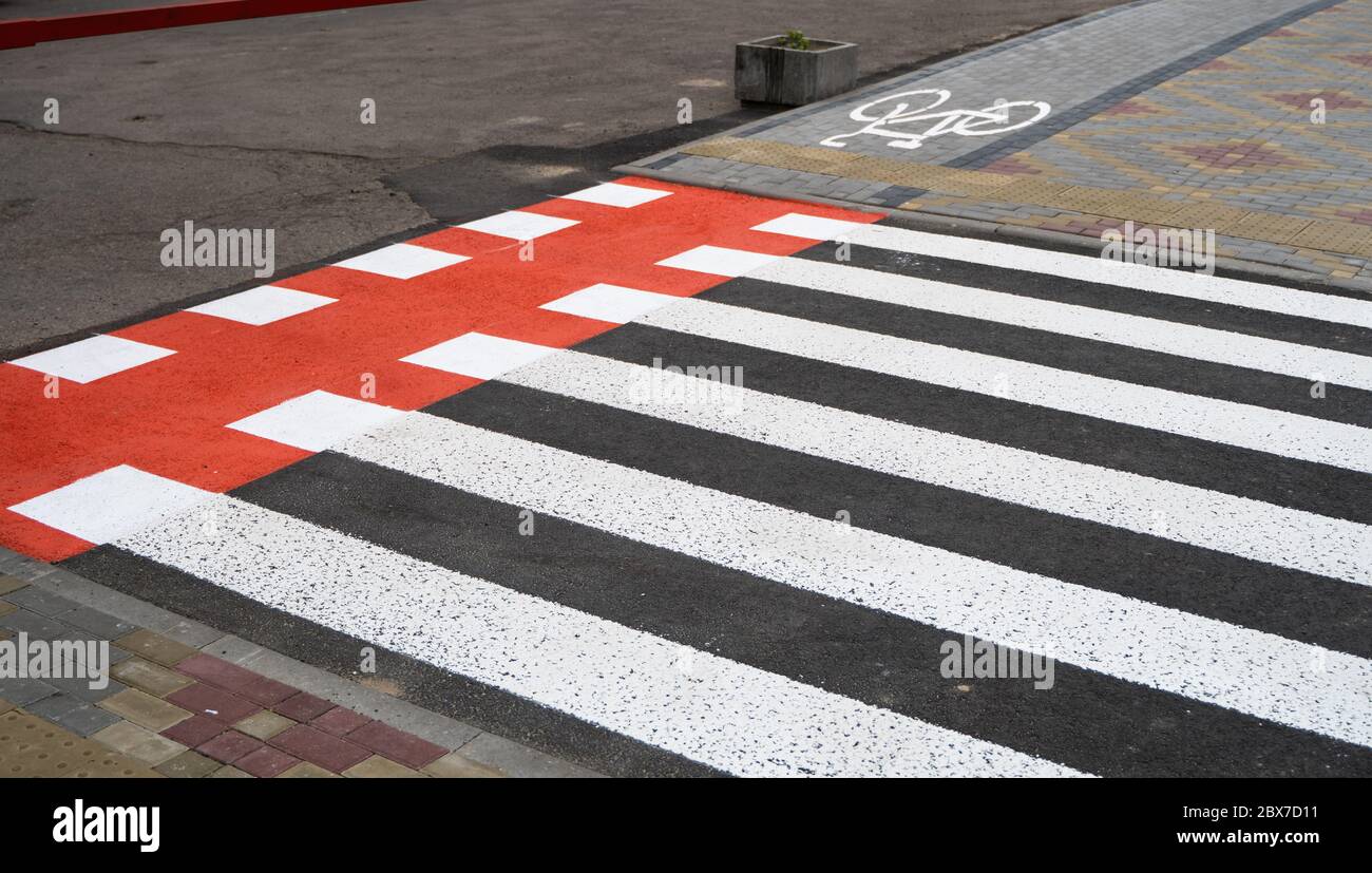Cycling path with a symbol of bike on a ground through avtomobile road ...