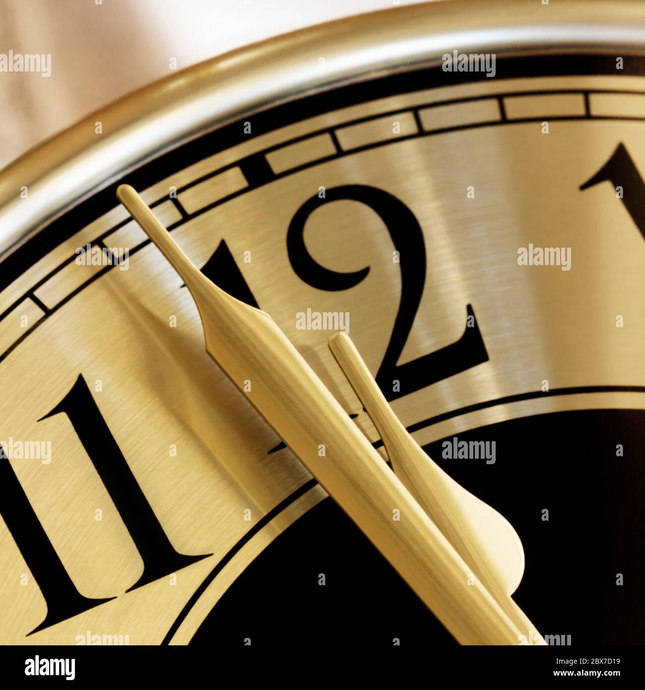 Golden clock face. Closeup on two minutes to midnight Stock Photo - Alamy
