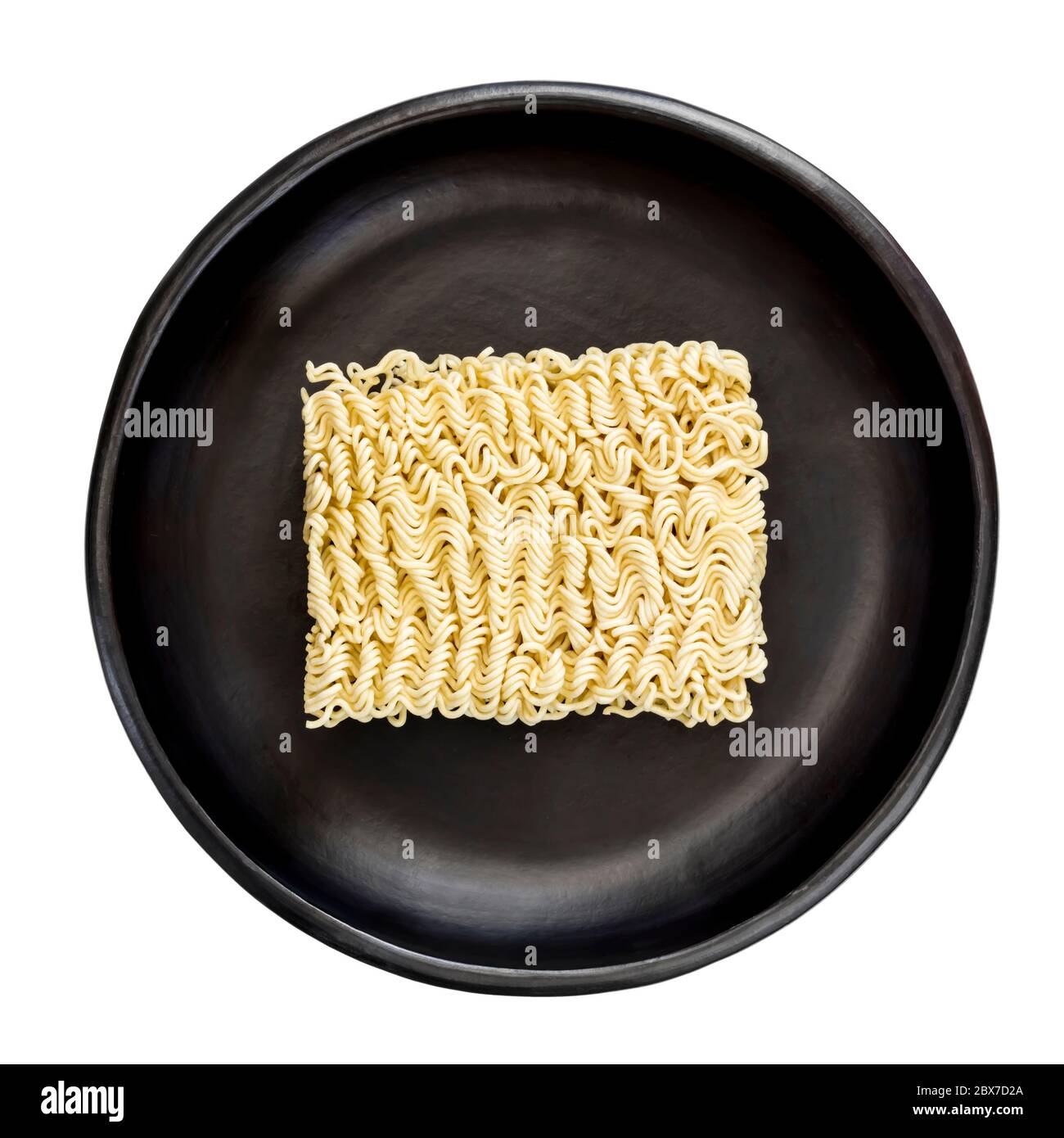 Raw Asian instant ramen noodles, isolated on white, in black bowl. Top ...