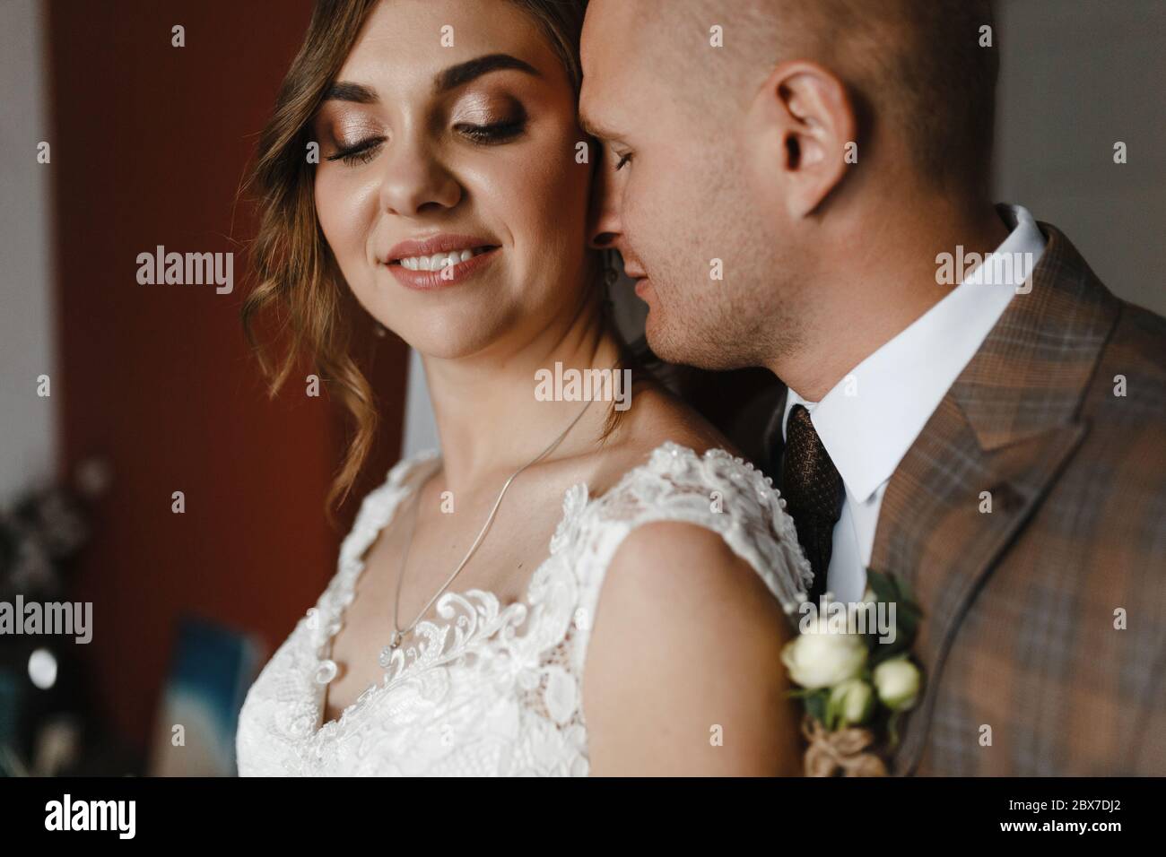 Groom kissing the bride on the neck. Bride and groom portrait Stock ...