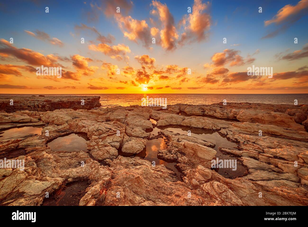 Beautiful colorful sunset near the sea at Cyprus with dramatic clouds ...