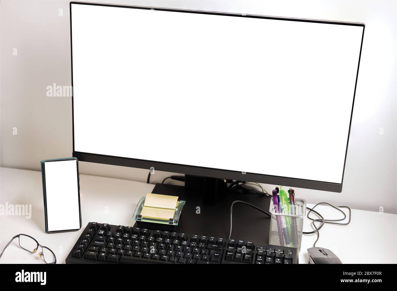 Close up macro view of computer monitor and mobile phone with mockup ...