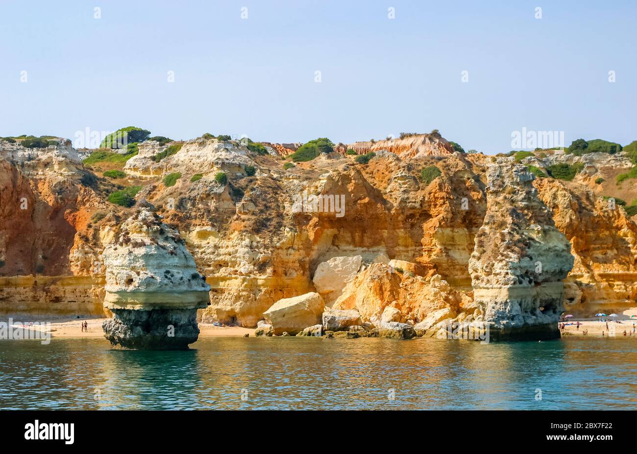 Praia do Torrado by Praia dos Caneiros, a picturesque beach with caves ...