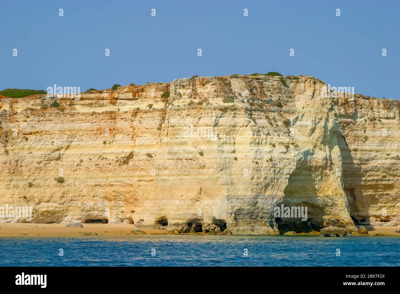 Picturesque large sea cave and geological features in the cliffs along ...