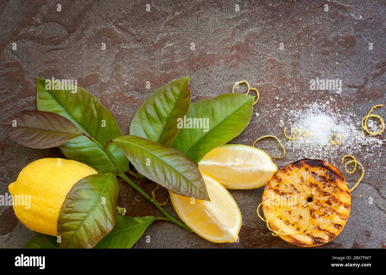 Lemon food background. Whole, cut, grilled, zested, with sea salt. Over ...