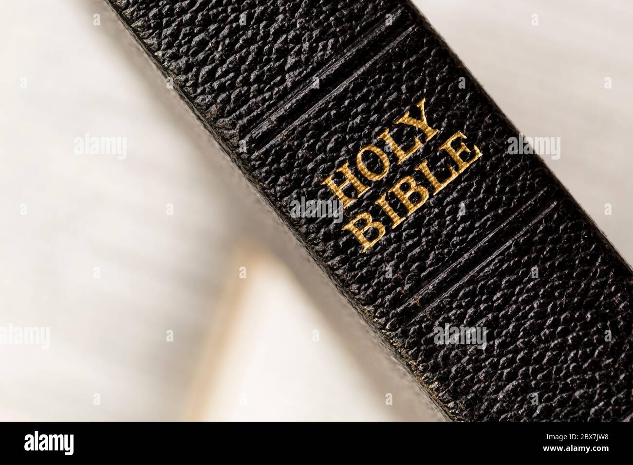 Old holy Bible spine over blurred open book Stock Photo - Alamy