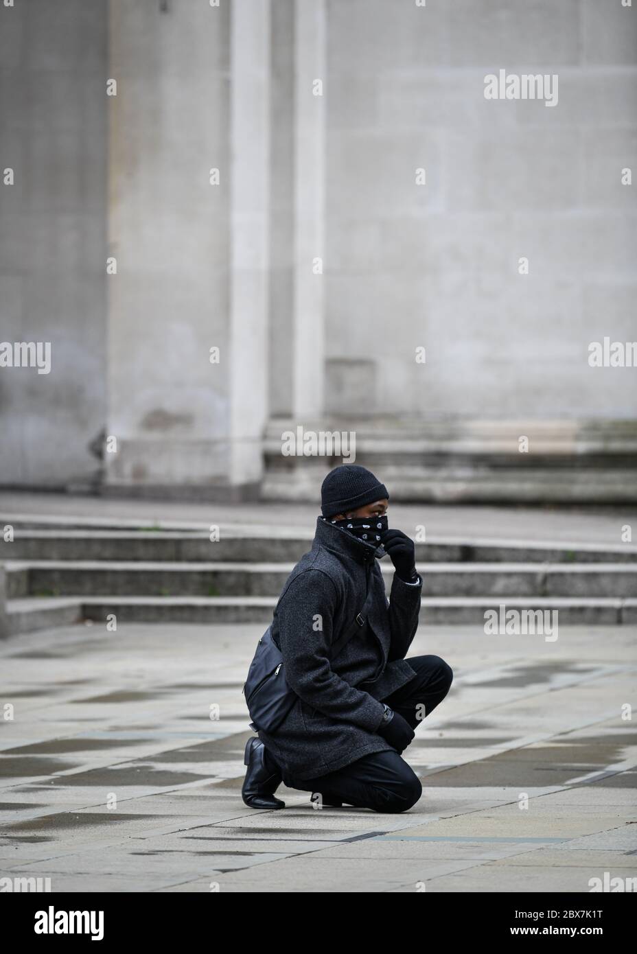 A lone protester takes a knee during the demonstration.Hundreds of ...