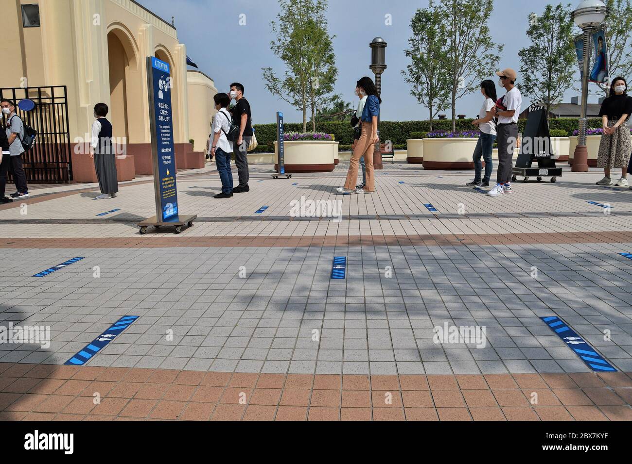 Visitors make a line while social distancing during the demonstration ...