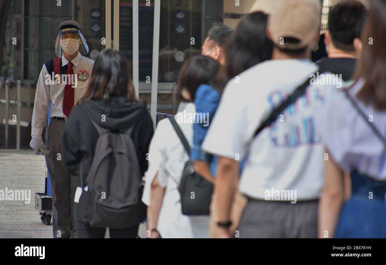 Visitors make a line while social distancing during the demonstration ...