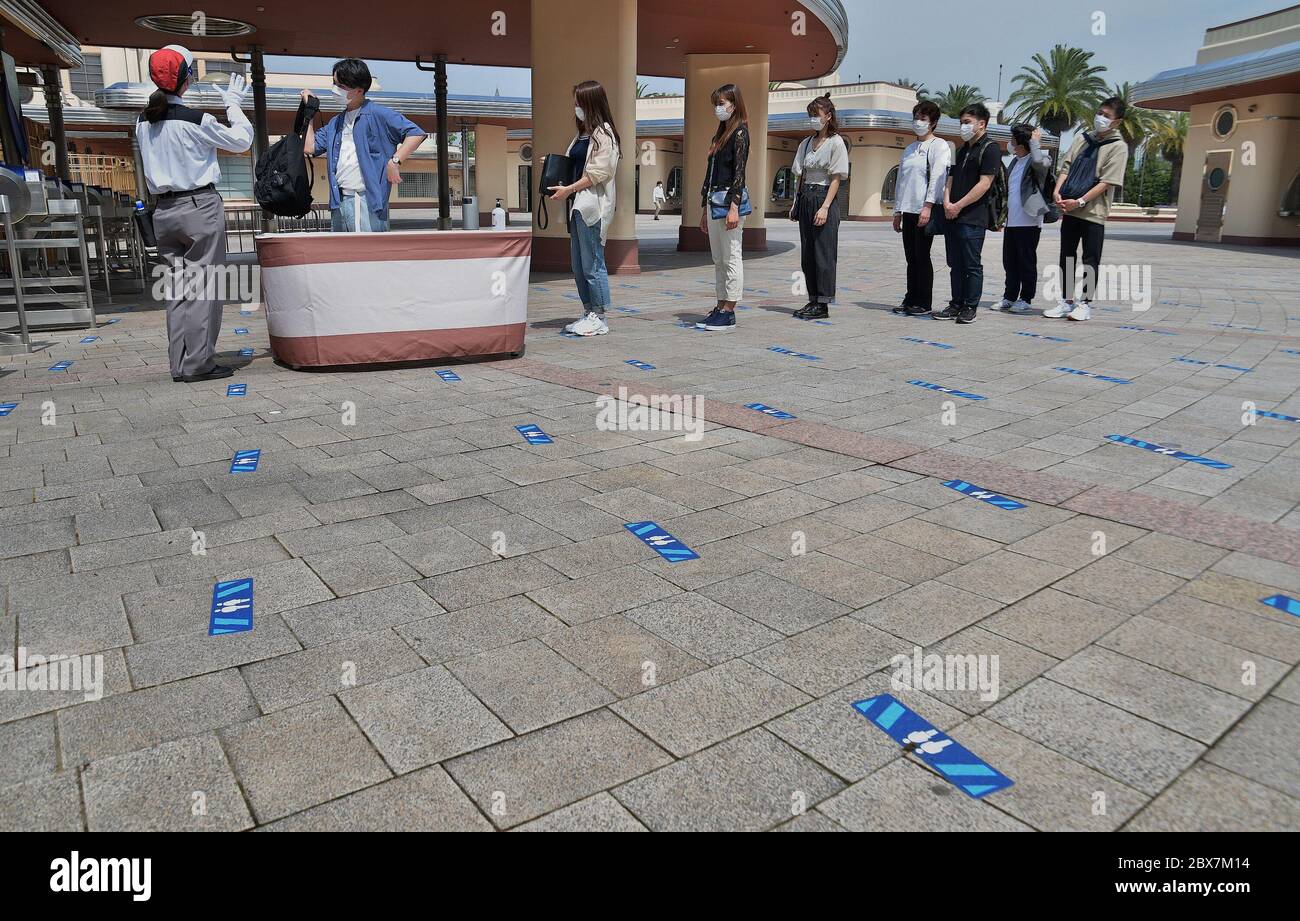 Visitors make a line while social distancing during the demonstration ...