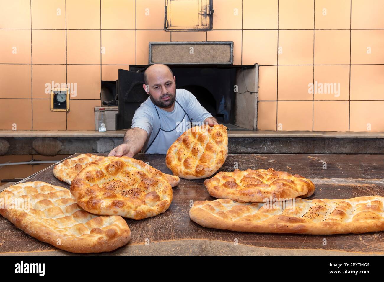 A baker making Turkish pita bread. Bakery,Turkish pita bread making ...