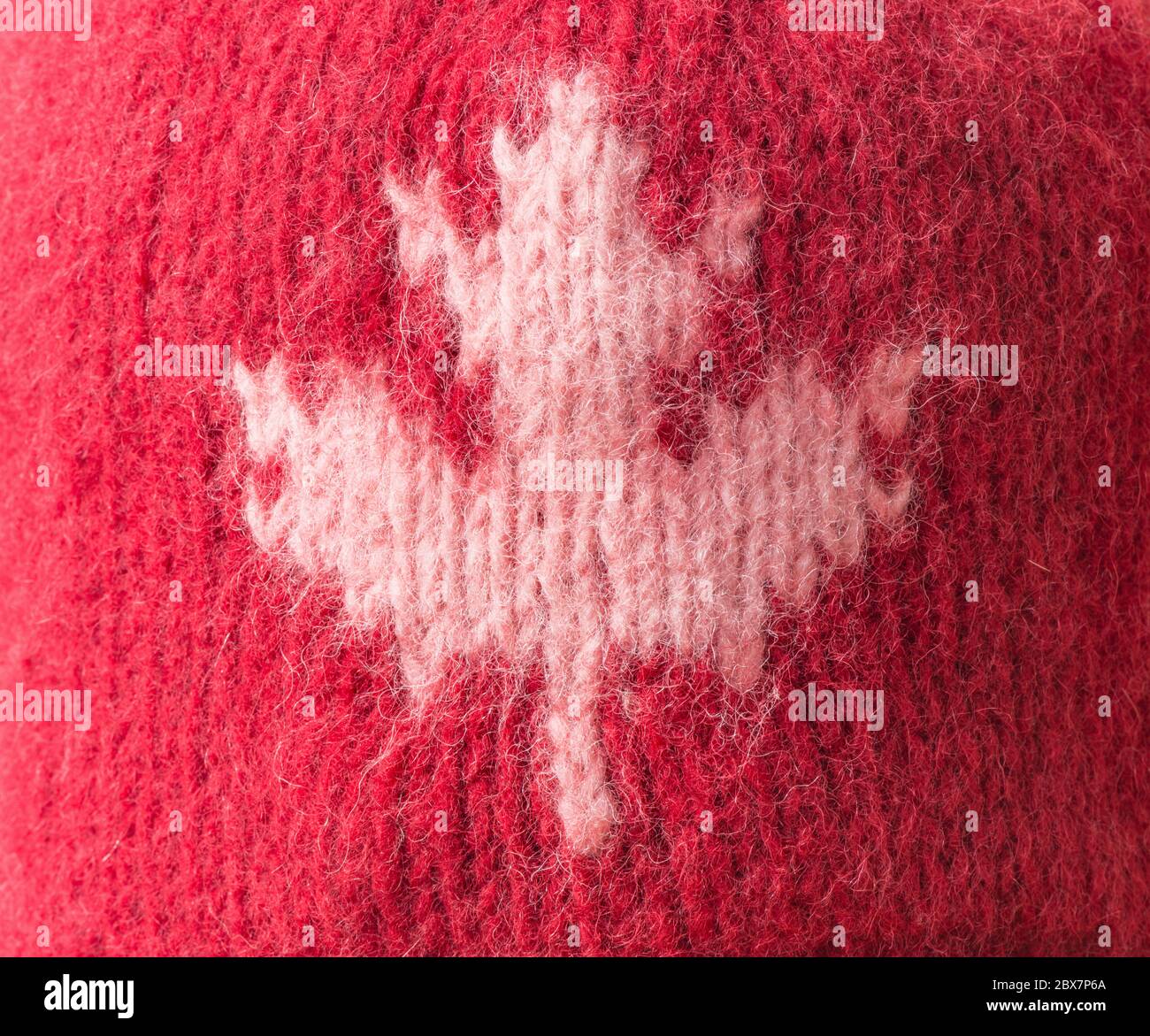 Canadian symbol on the red woolen background Stock Photo - Alamy