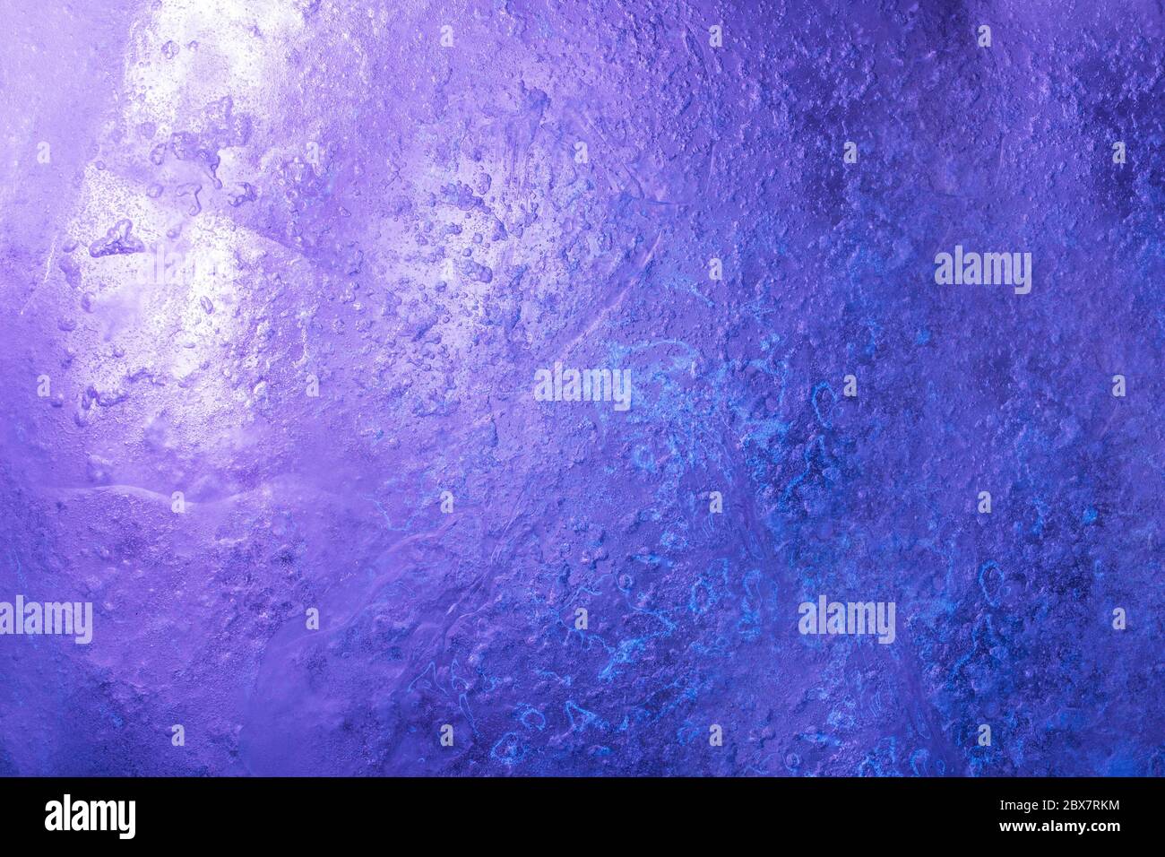Purple and blue highlightened abstract ice texture with air bubbles ...