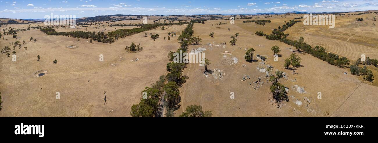 Aerial panoramic image of the dry bushland strewn with granite boulders ...