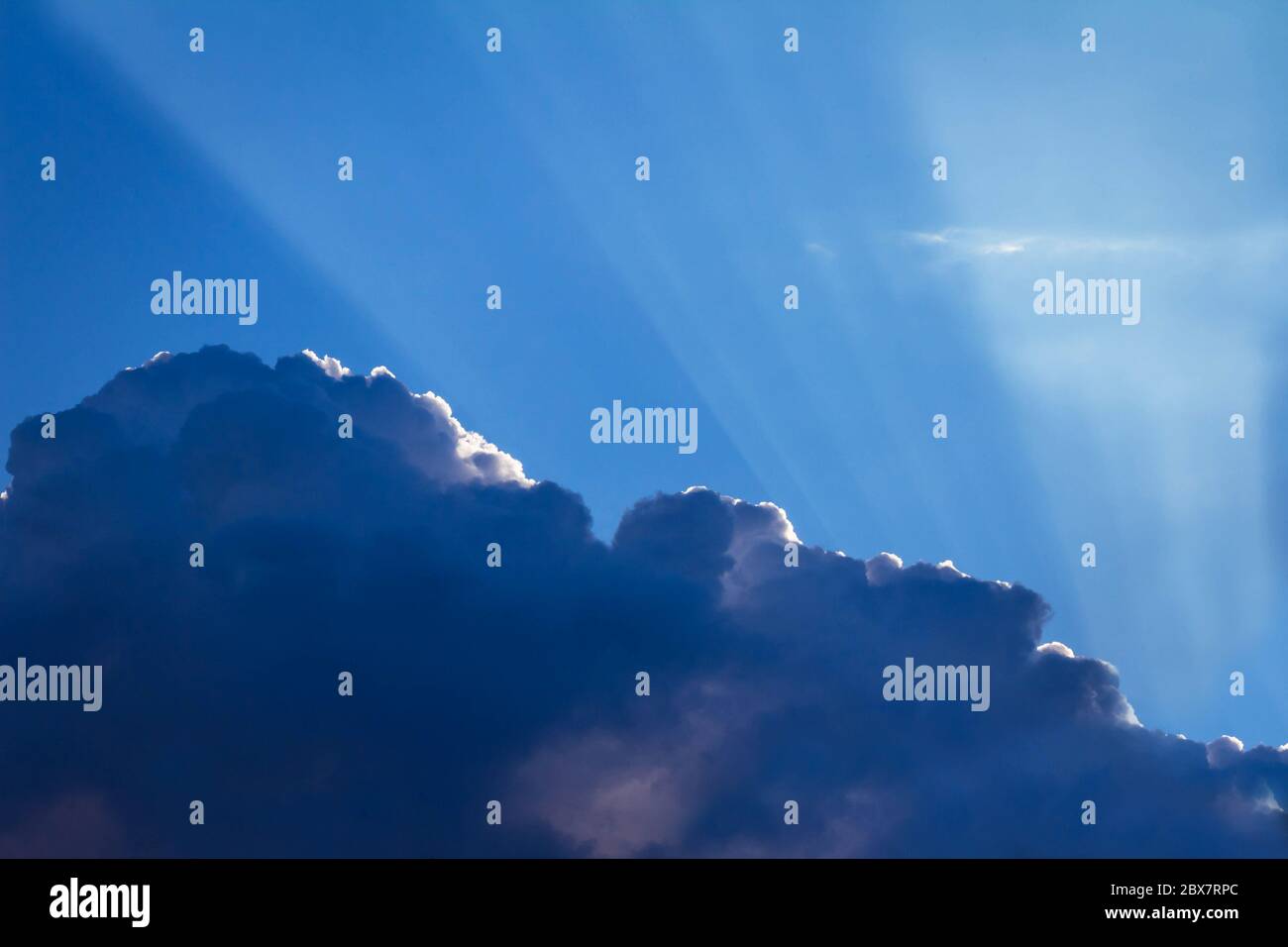 Evening blue toned sunset fluffy clouds with sun beam lights Stock ...