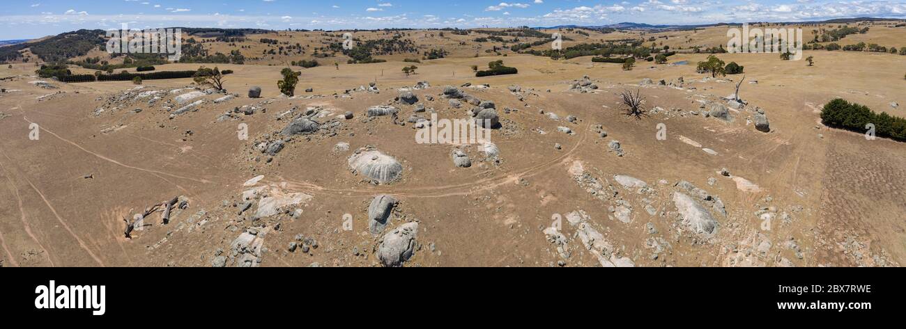 Aerial panoramic image of the dry bushland strewn with granite boulders ...