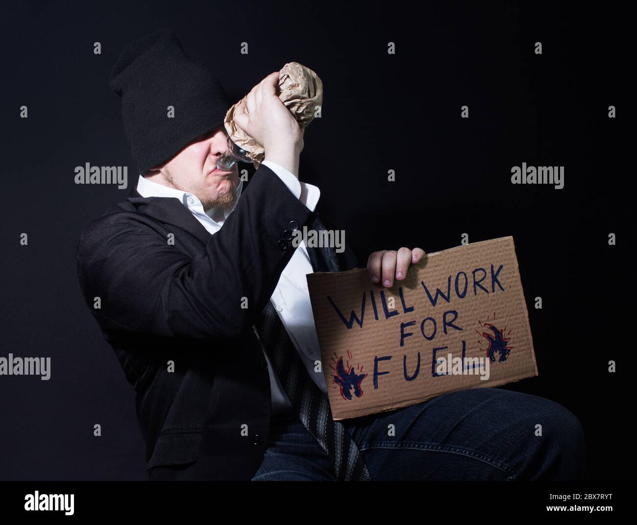 hoto of a alchoholic homeless business man drinking from a bootle and ...