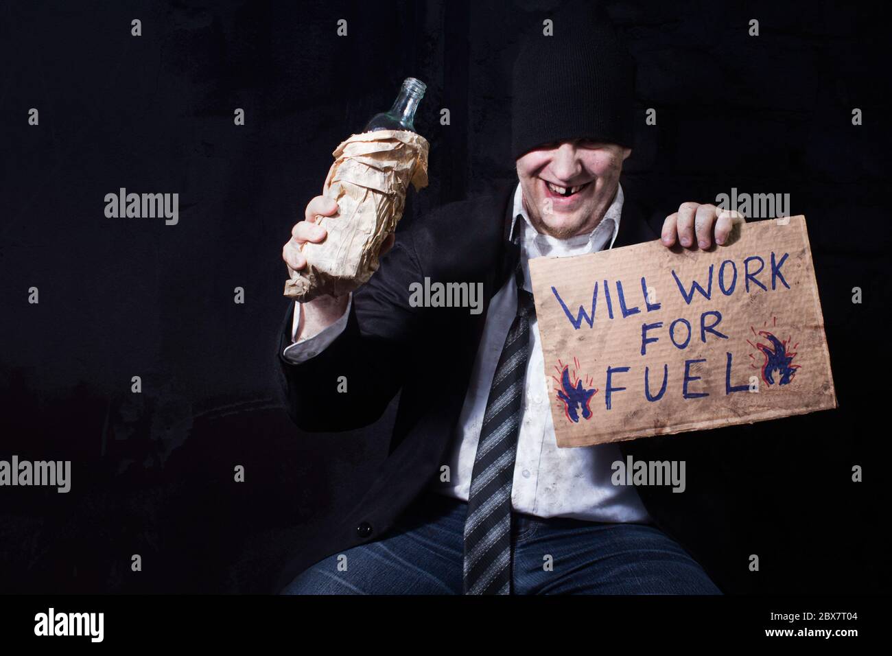 Photo of a happy alcoholic homeless businessman with cardboard sign ...