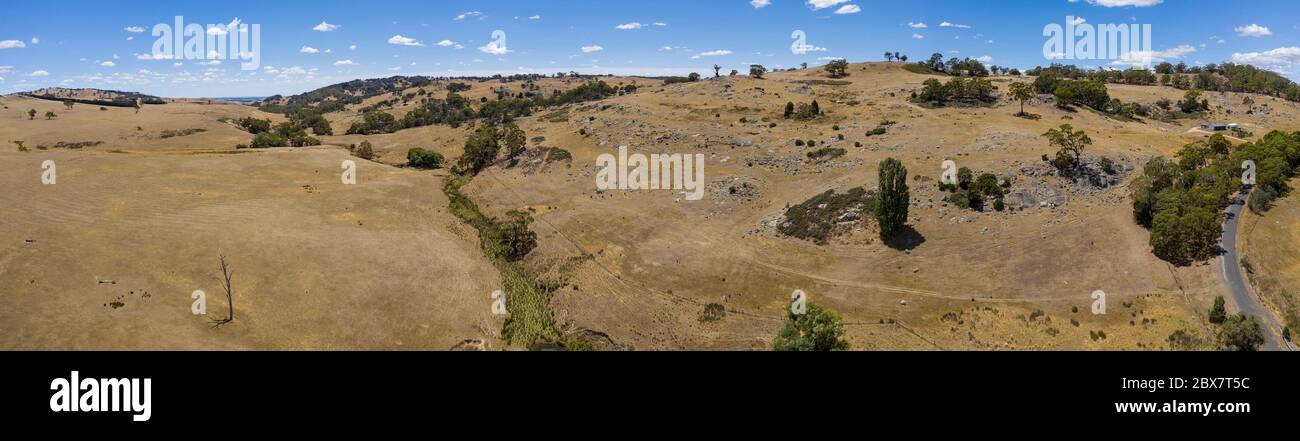 Aerial panoramic image of the dry bushland strewn with granite boulders ...