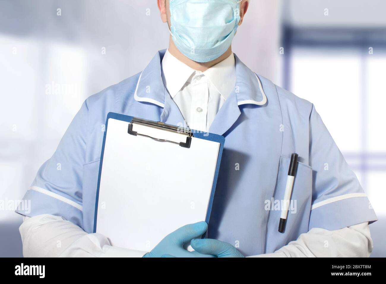 Photo of a lab assistant in full outfit and rubber gloves holding a ...