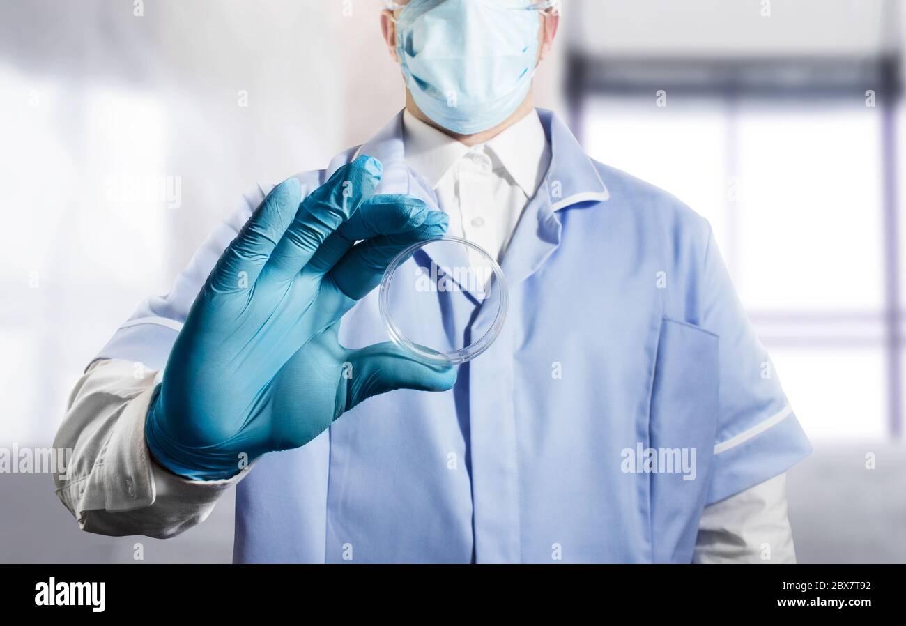 Photo of a lab assistant holding a petri cup in full body outfit and ...