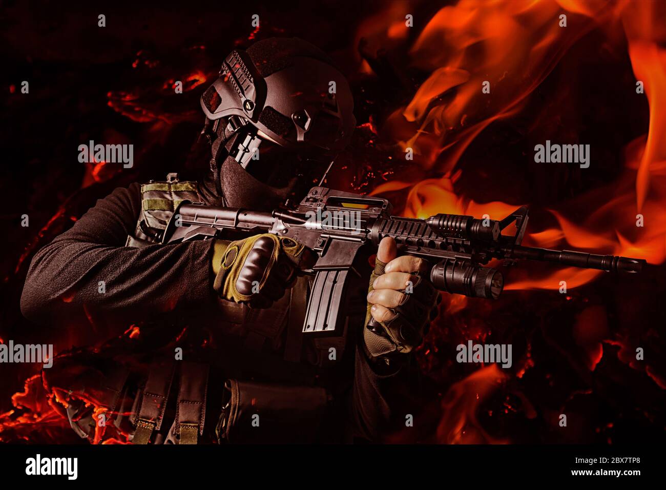 Photo of a swat soldier aiming automatic rifle with flame effects Stock ...