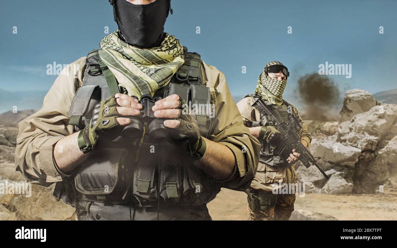 Photo of a fully equipped soldiers posing on a desert battlefield ...