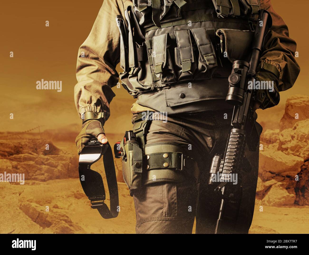 Photo of a soldier in military outfit standing on orange desert ...