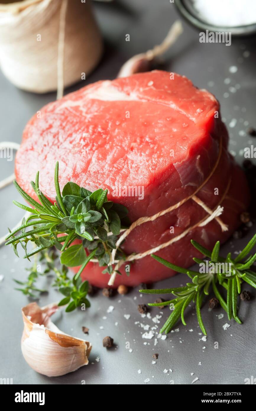 Raw beef fillet steak with herbs, spices and garlic Stock Photo - Alamy