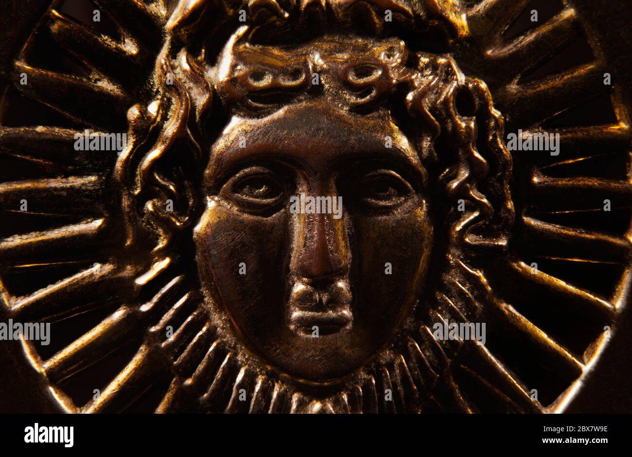 Metal greek male face bronze relief close up photo Stock Photo - Alamy
