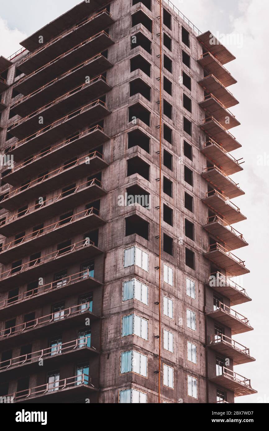 Art photo of a high-rise building under construction made of concrete ...
