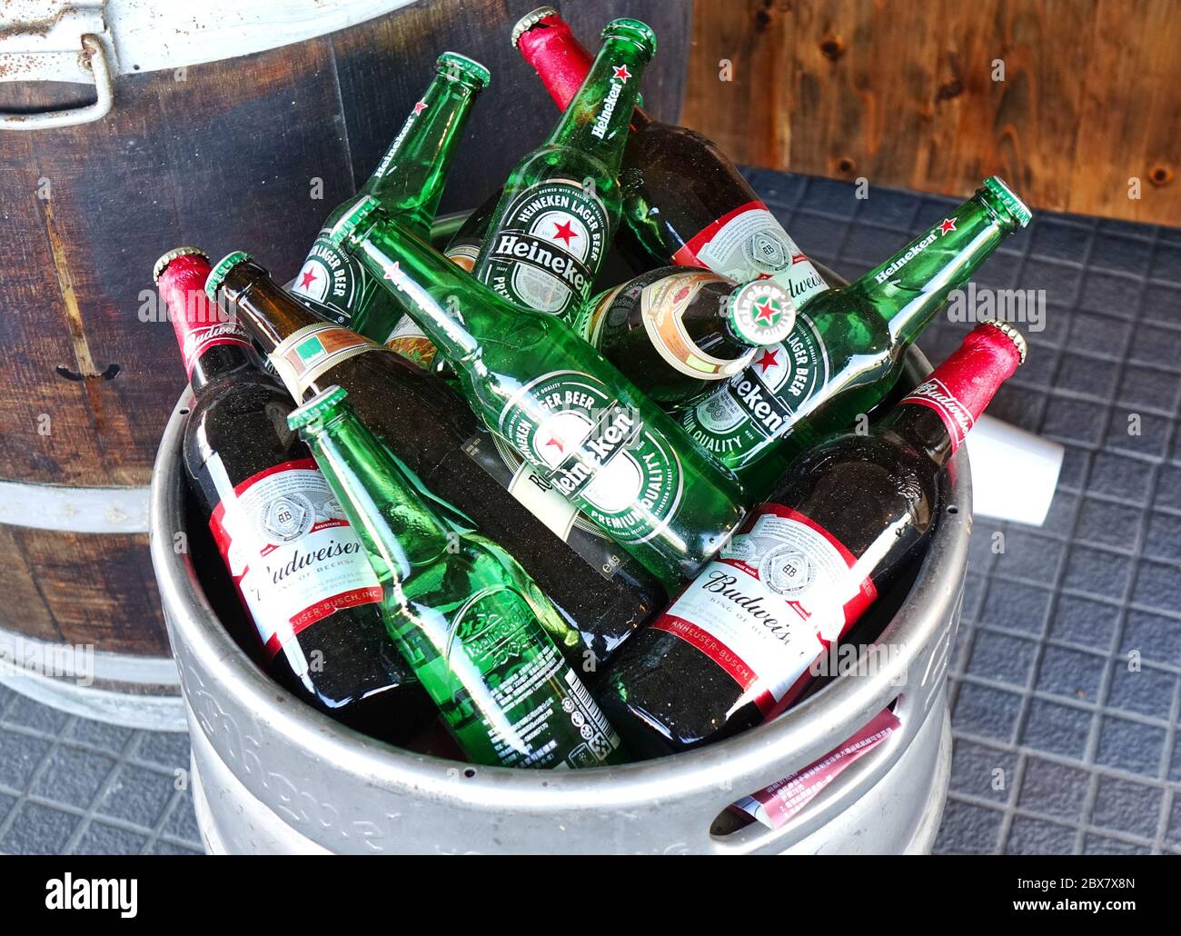 KAOHSIUNG, TAIWAN -- JUNE 2, 2019: A food stall prepares beer bottles ...