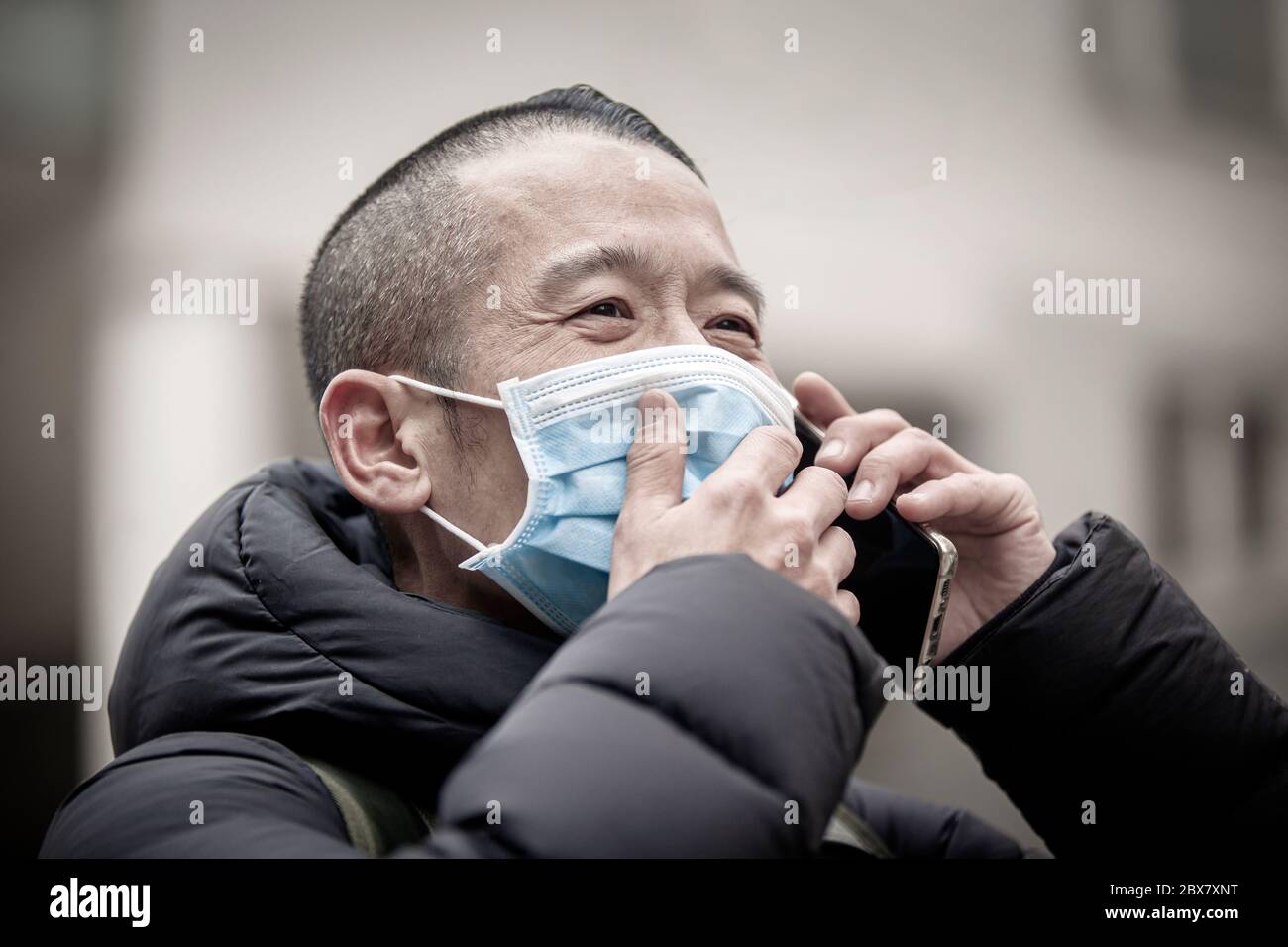 Middle aged Asian man wearing medical face mask Stock Photo - Alamy