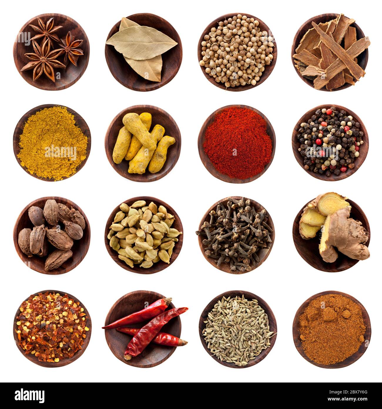 Collection of spices in small wooden bowls, isolated on white. From top ...