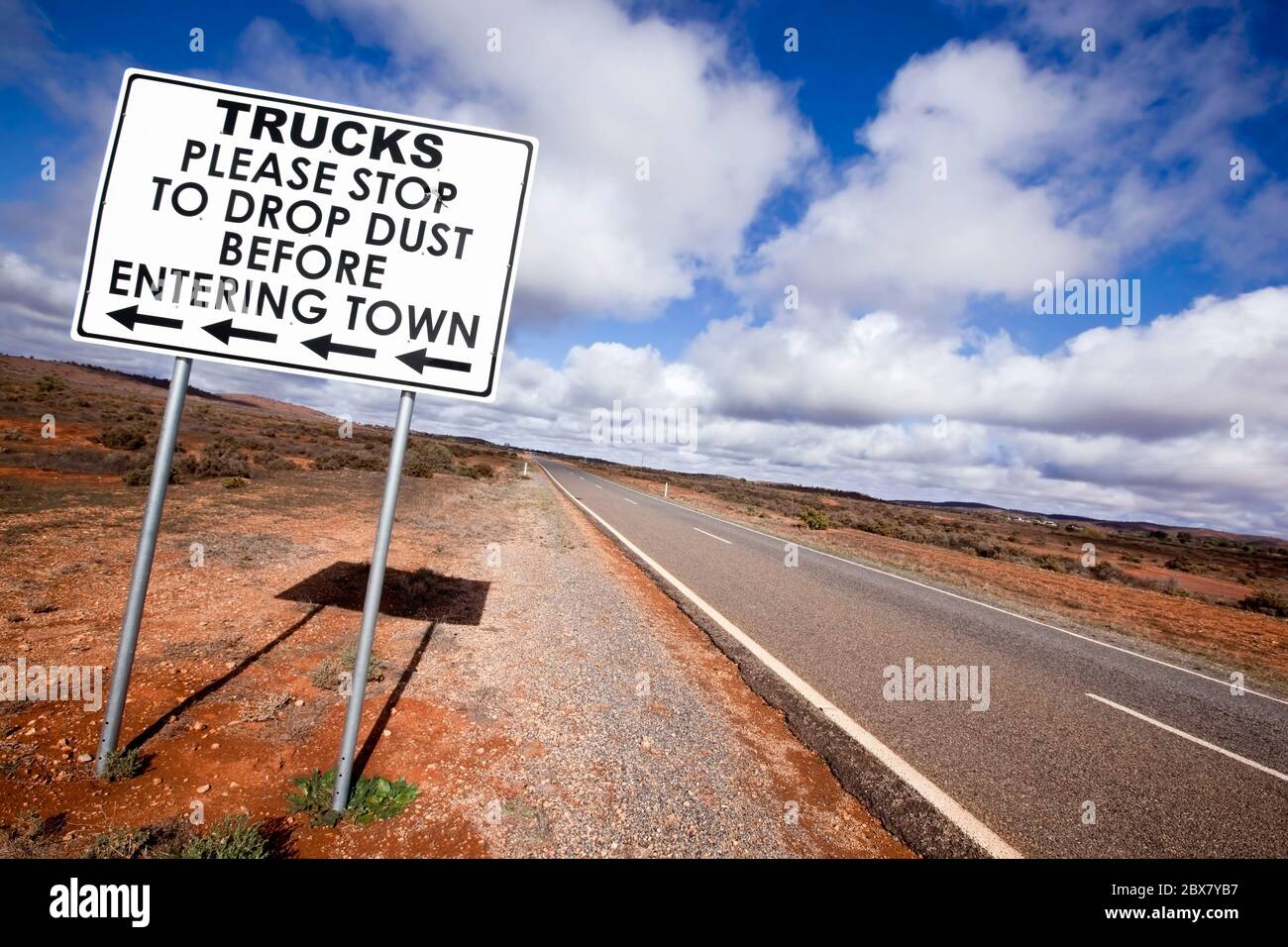 Road sign in the Australian outback, asking trucks to stop to drop dust ...