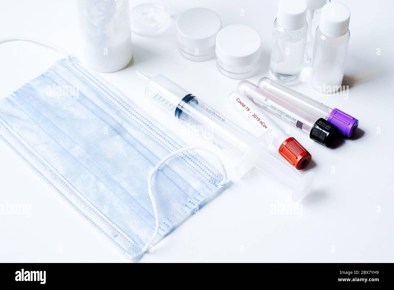 Surgical mask, syringe and blood tubes Stock Photo - Alamy