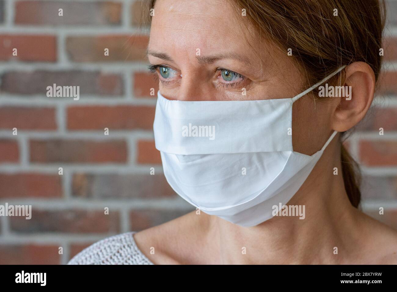 Woman in her fifties wearing a mask Stock Photo - Alamy