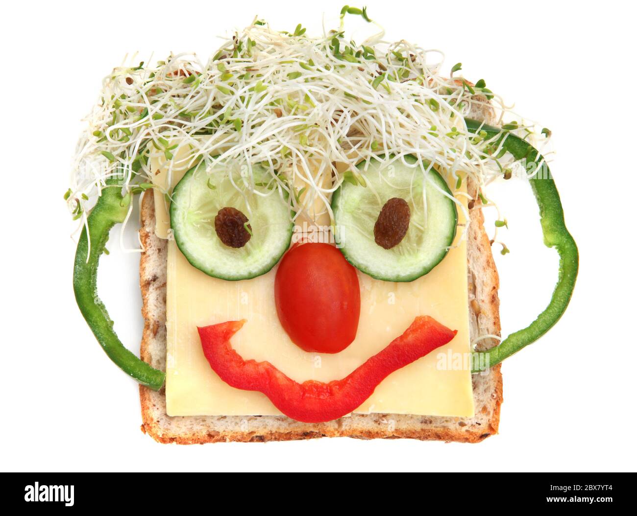 Face on bread, made from cheese, sprouts, capsicums, tomato, cucumber ...