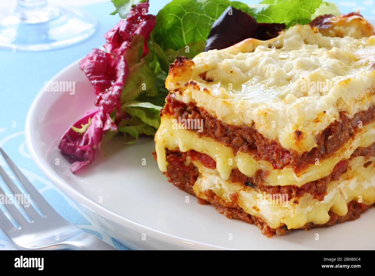 Beef lasagne with salad. Melting mozzarella and ricotta cheeses ...