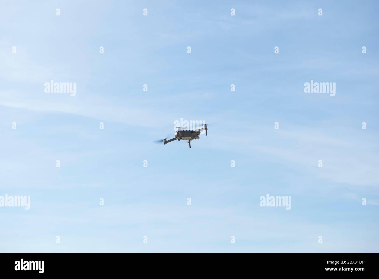 Drone flying in blue sky with clouds in the background. Drone flying ...