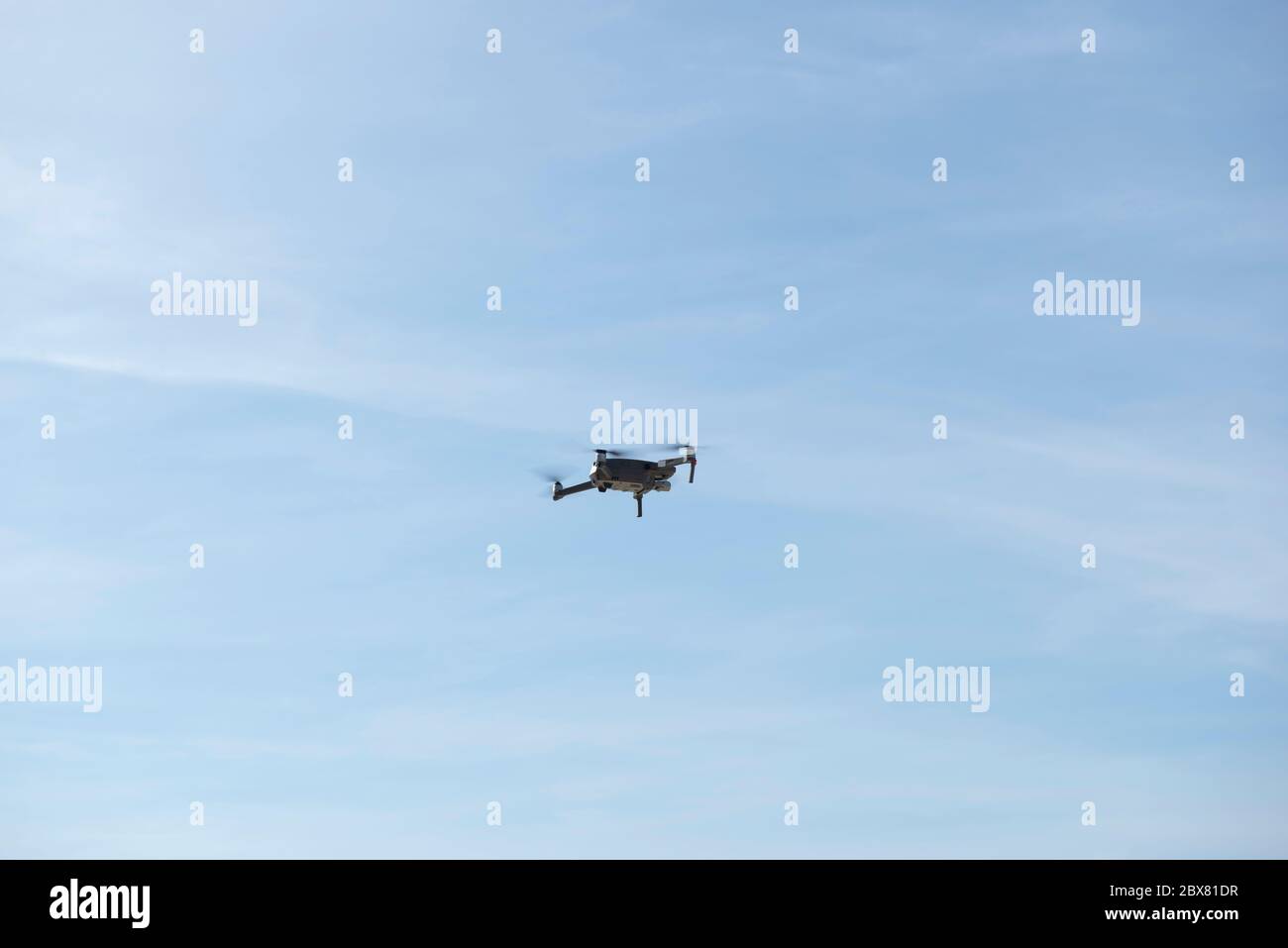 Drone flying in blue sky with clouds in the background. Drone flying ...